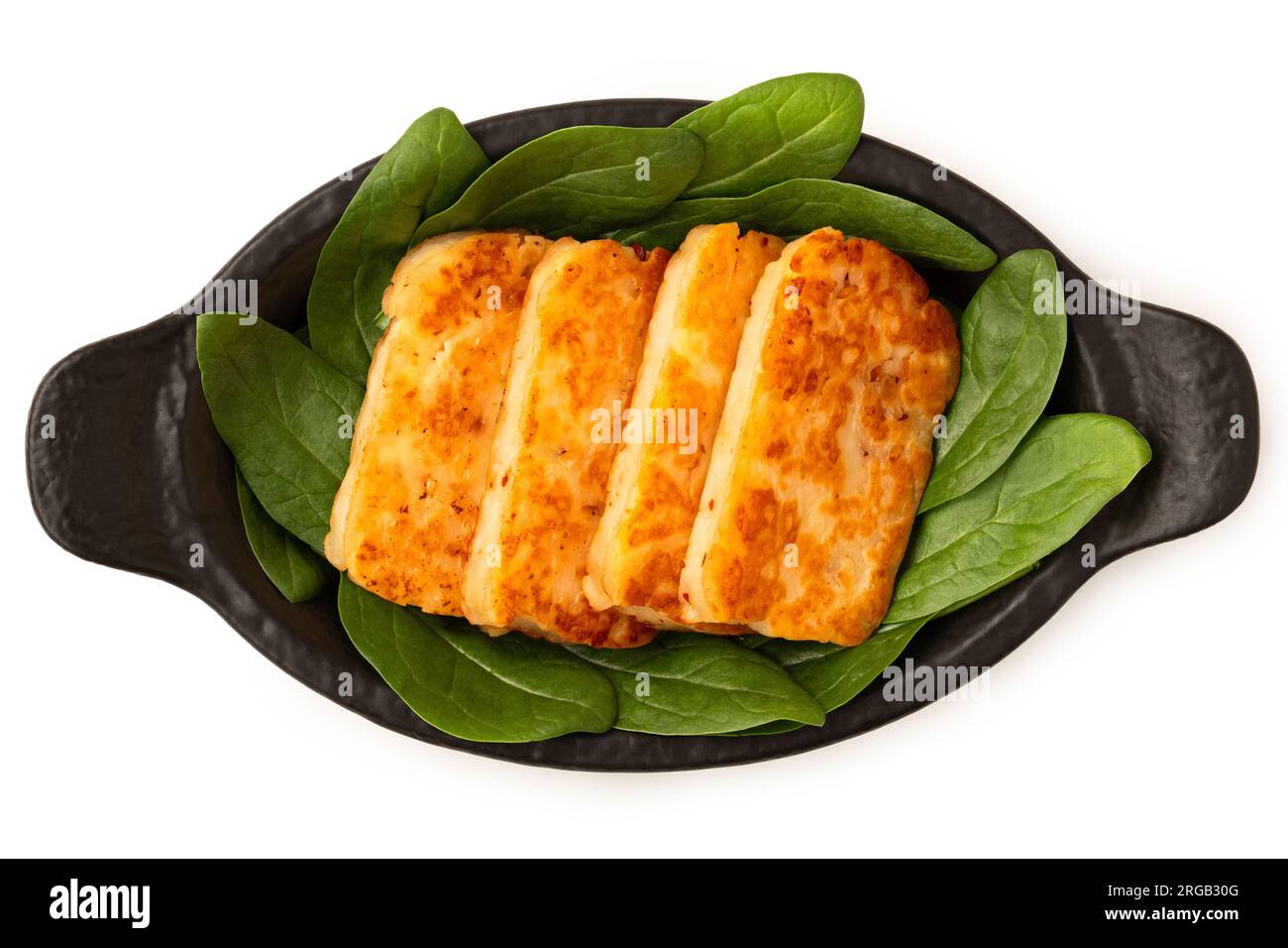 Fried slices of halloumi cheese with red chilli and fresh spinach in a ...