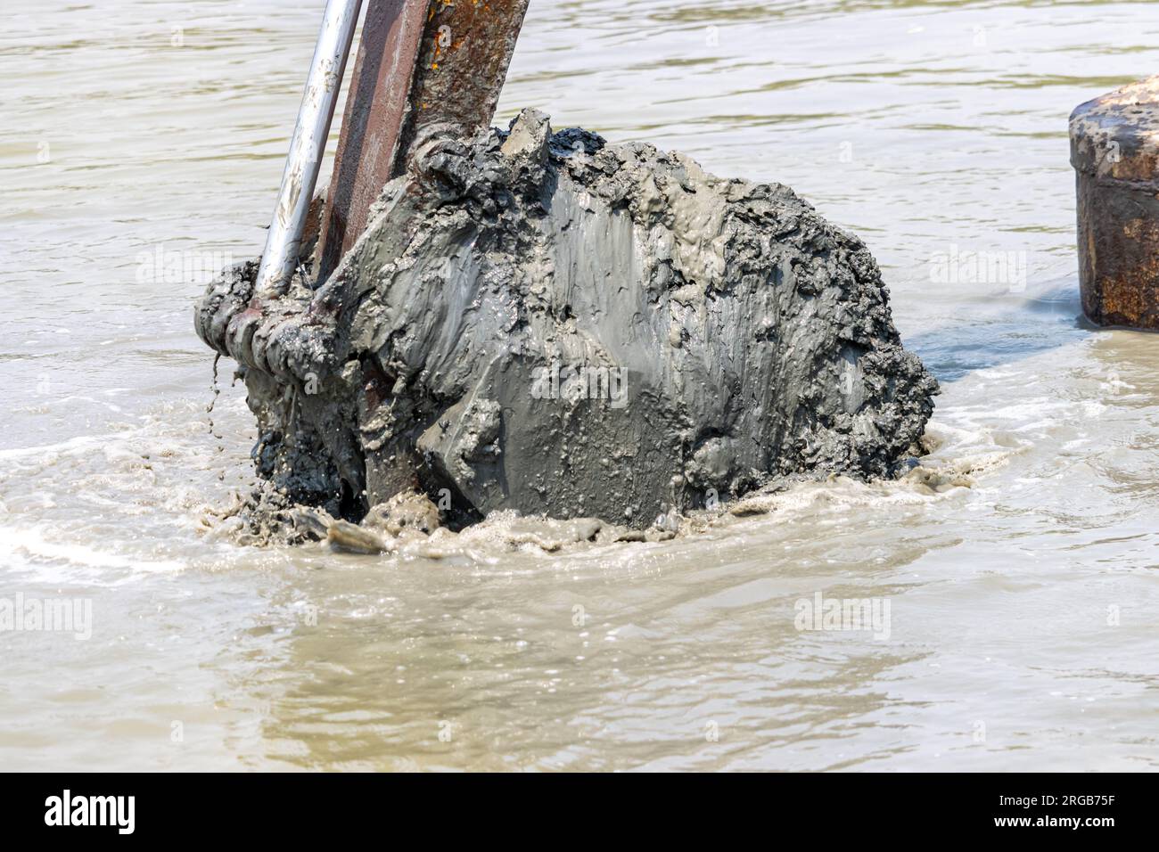 Dredging the bottom of water area, view of the bucket of the floating ...