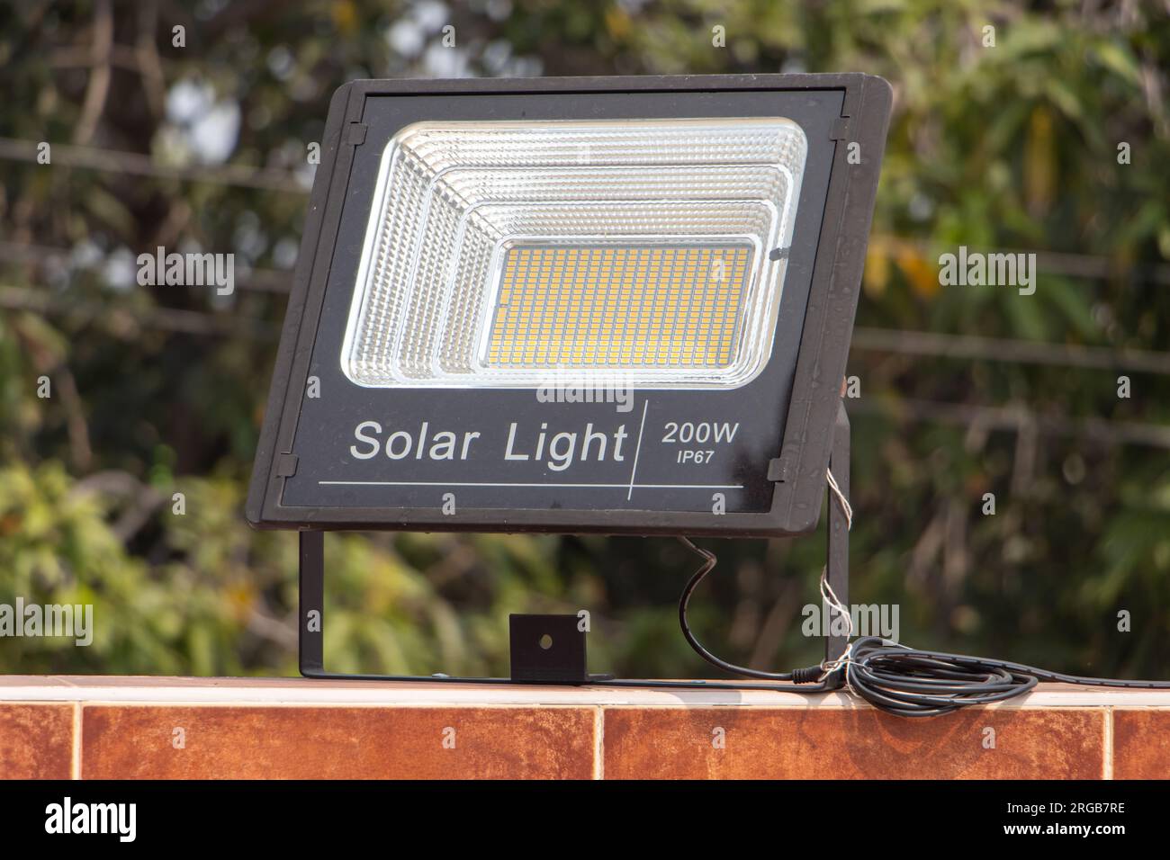 Reflector powered by solar panels fixed on the wall Stock Photo - Alamy