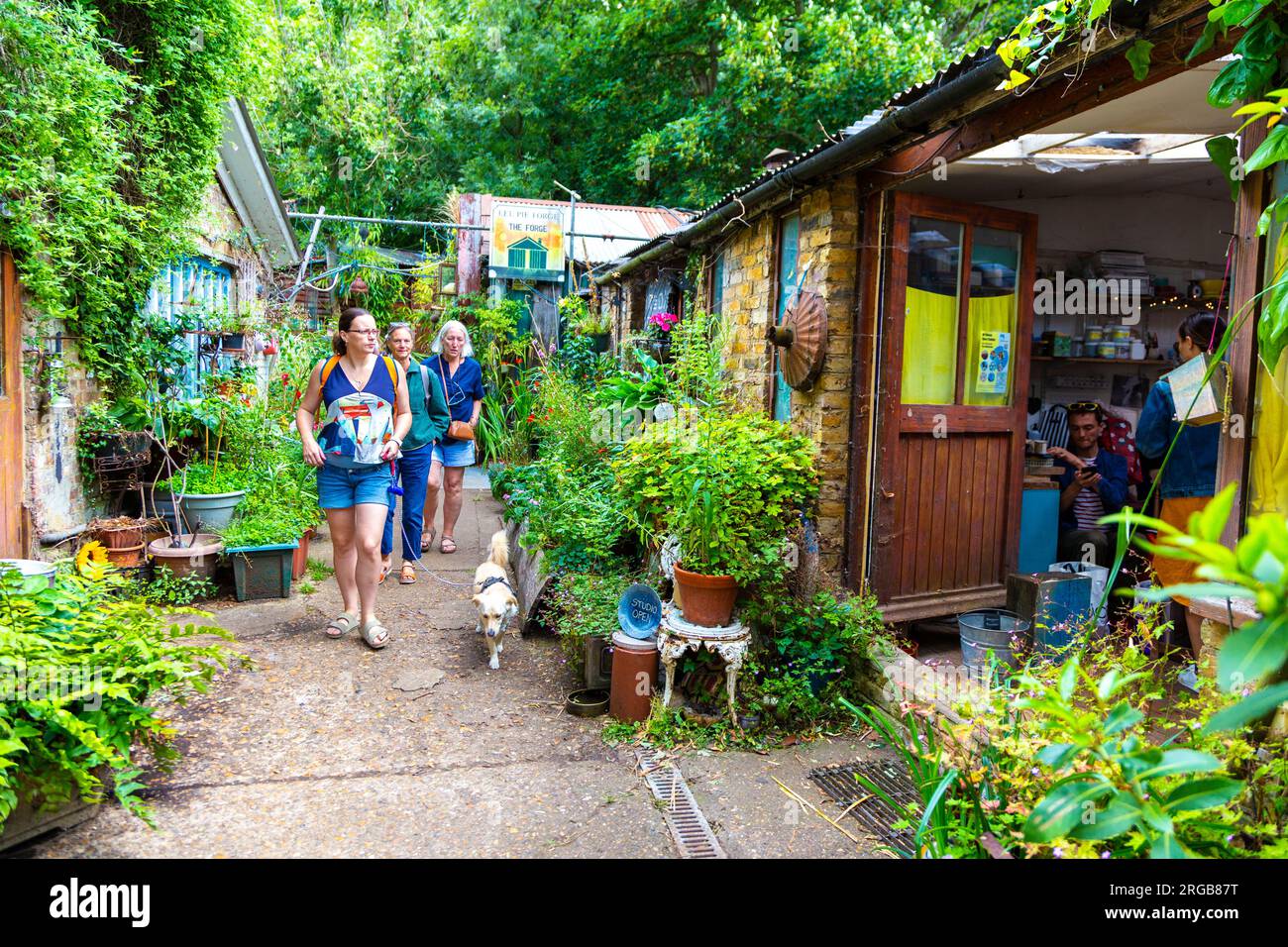 Visitors walking around on artists studios open day at Eel Pie Island artist community in ...