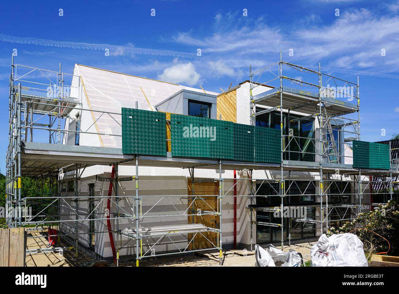 An unfinished modern single-family residential house, surrounded by ...