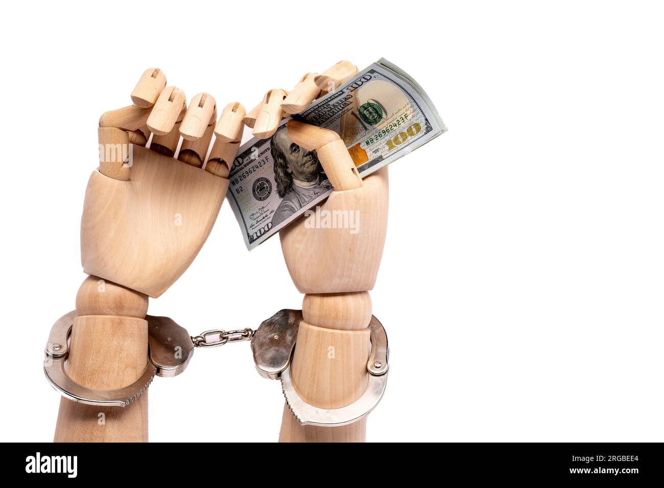 bail reform concept with wooden hands handcuffed holding 100 dollar ...