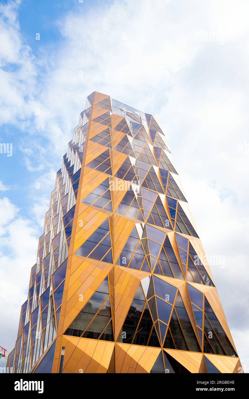 copper red brown pineapple skyscraper on blue cloudy sky. architect ...