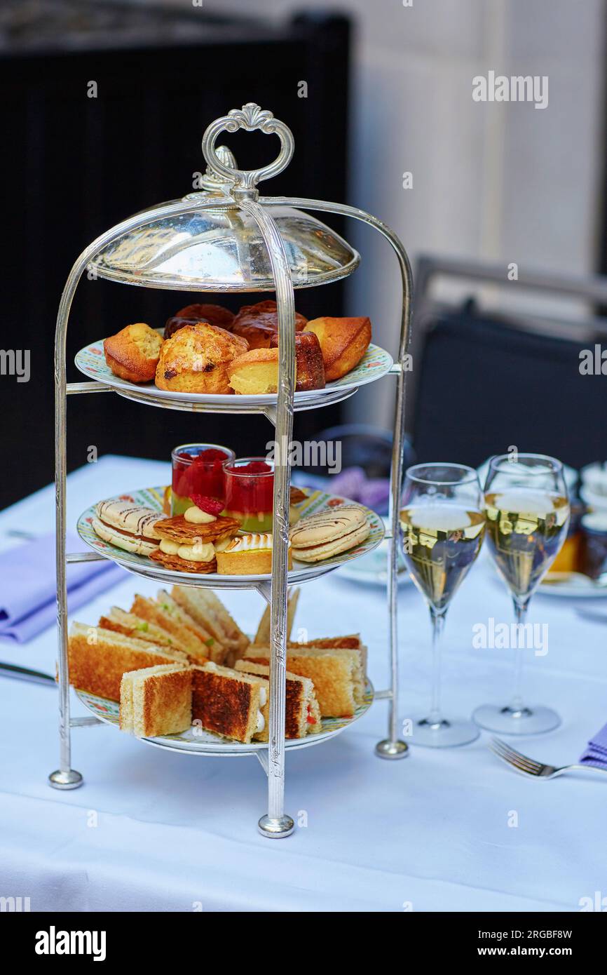 Selection of sandwiches and fancy cakes served for the ceremony of ...