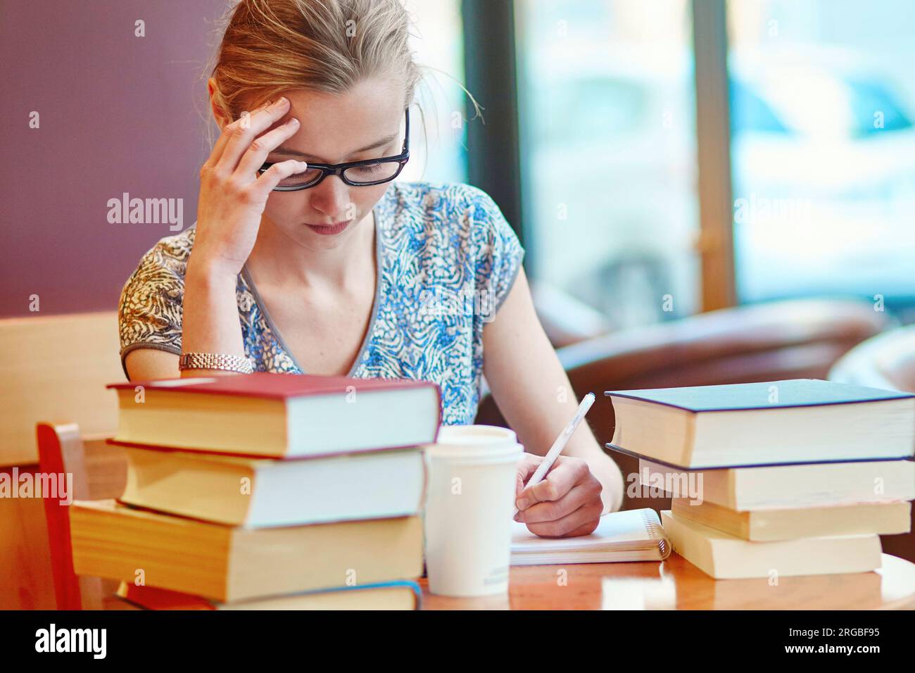 Student with books and papers, studying at home. Quarantine and closed ...