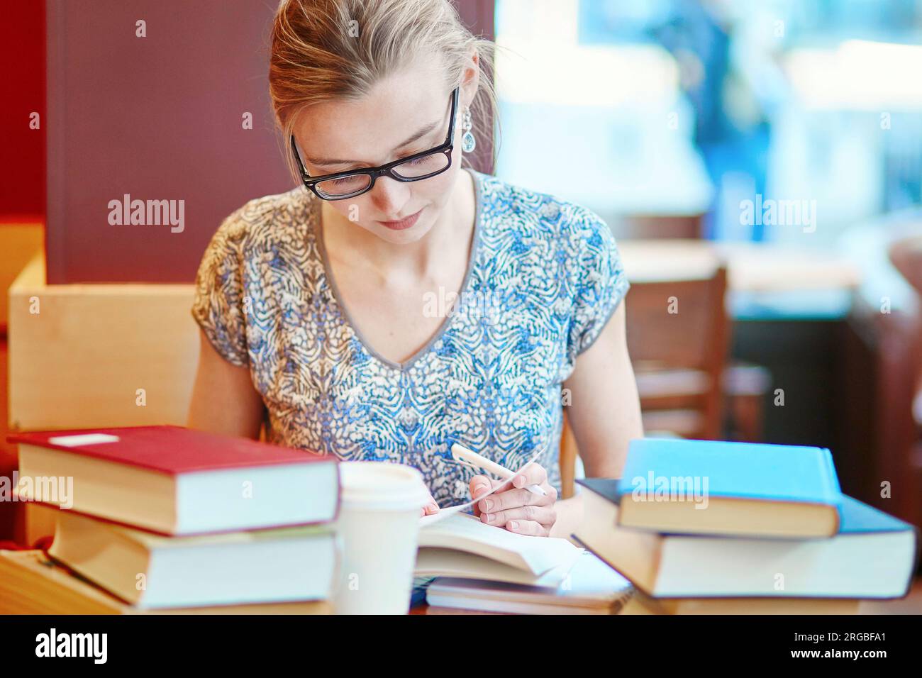 Student with books and papers, studying at home. Quarantine and closed ...