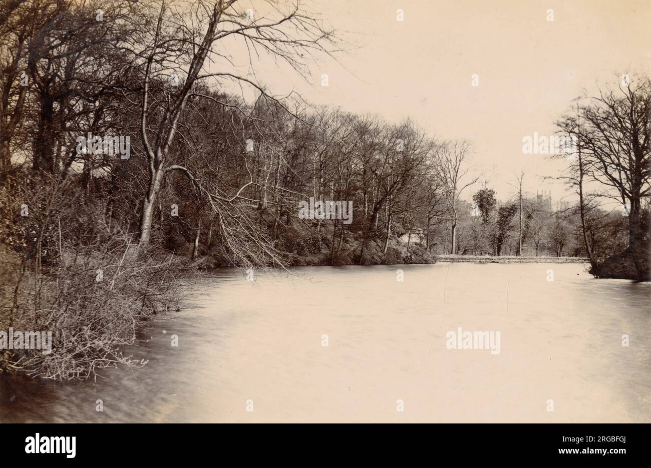 Lymm Dam, in the village of Lymm, Cheshire. The tower of St Mary's ...