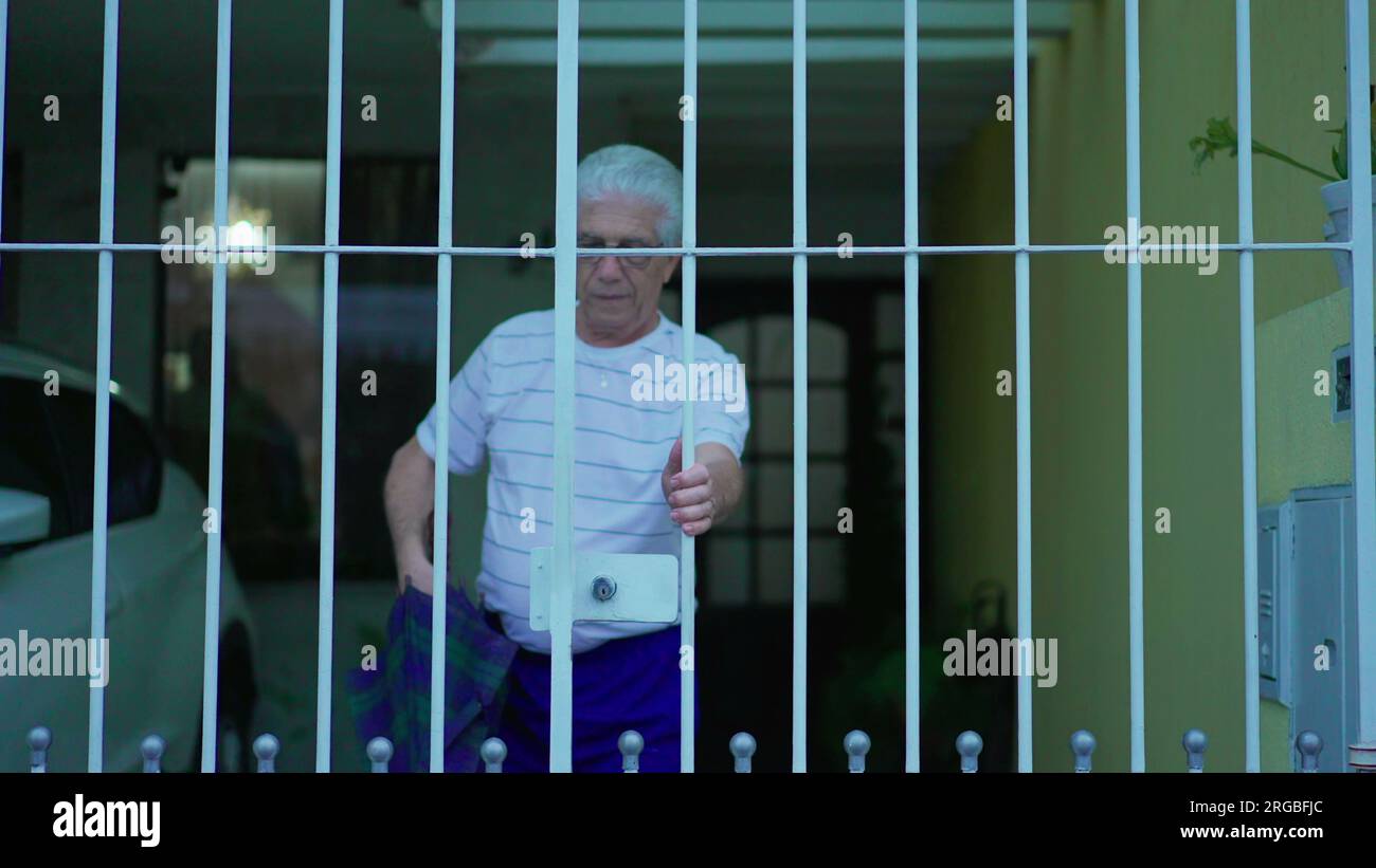 Senior Man Opens Gate, Steps out from Home with Umbrella in the Rain ...