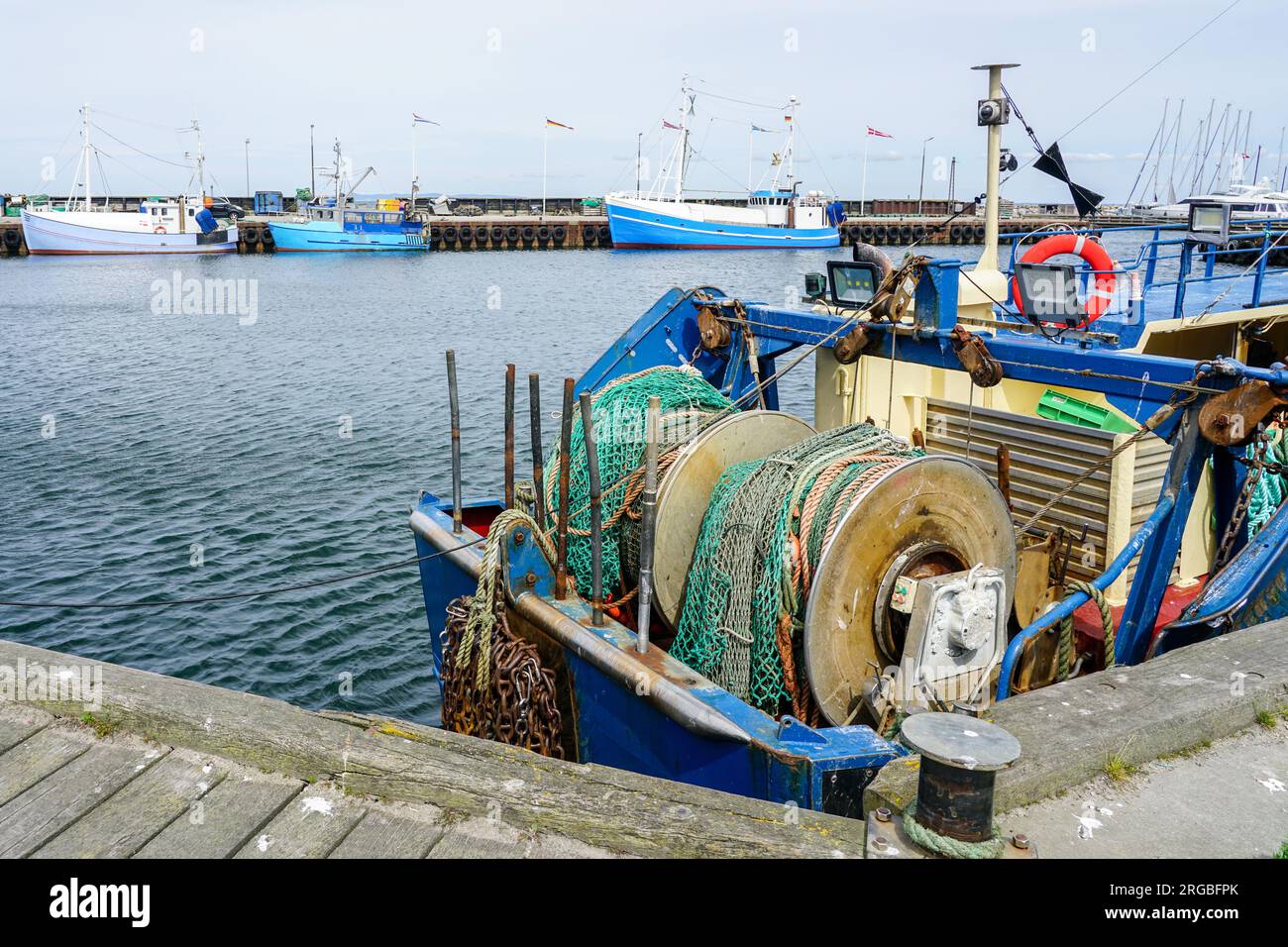 Fishing boat anchored at port, traditional vessel closeup with wrapped ...
