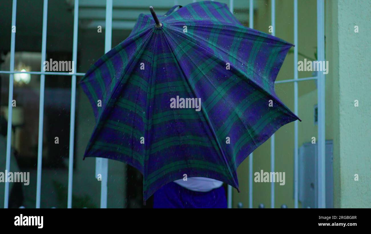 Senior Man Opens Gate, Steps out from Home with Umbrella in the Rain ...