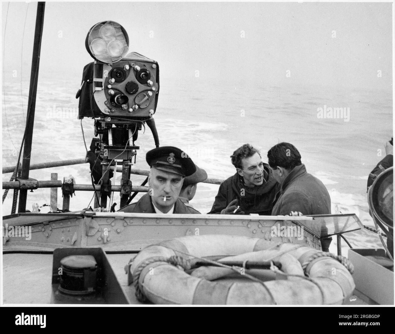 Raymond Baxter filming at sea, on 'location' Stock Photo - Alamy