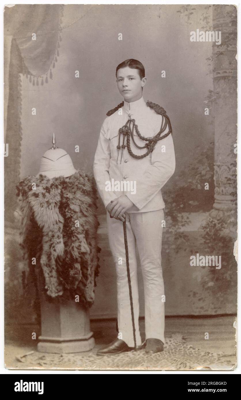 Studio photo, young soldier in white uniform, left shoulder aiguillette ...