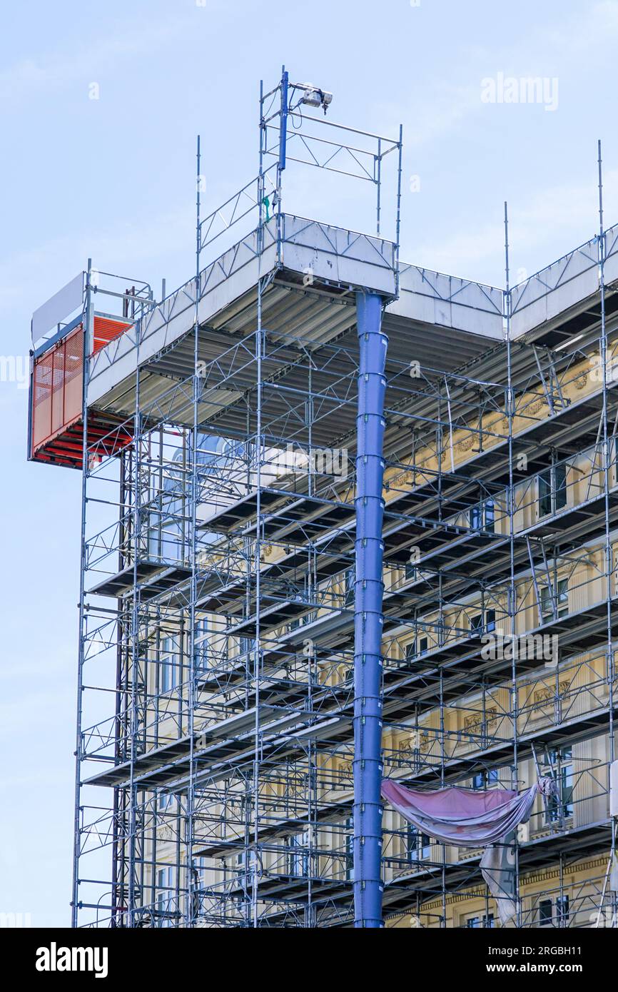 Repair of the facade of a historic tall house using scaffolding with ...