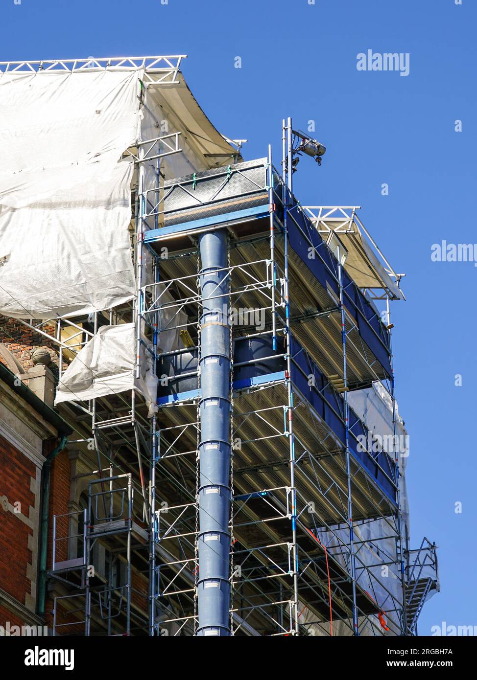 Repair of the facade of a historic tall house using scaffolding with ...