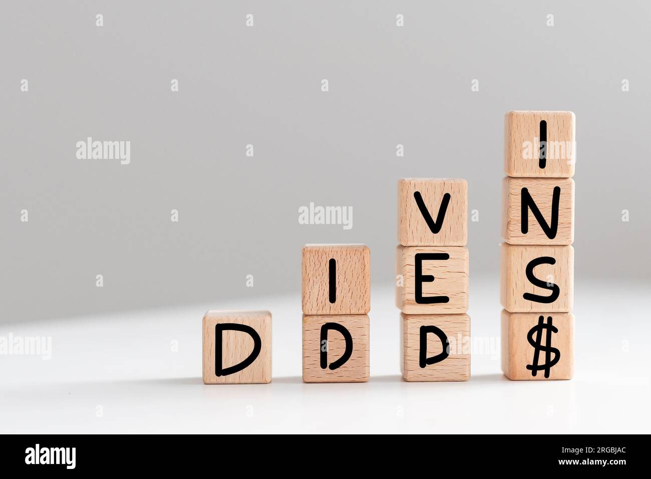 Conceptual image of the word dividend on letter cube with stock graph ...