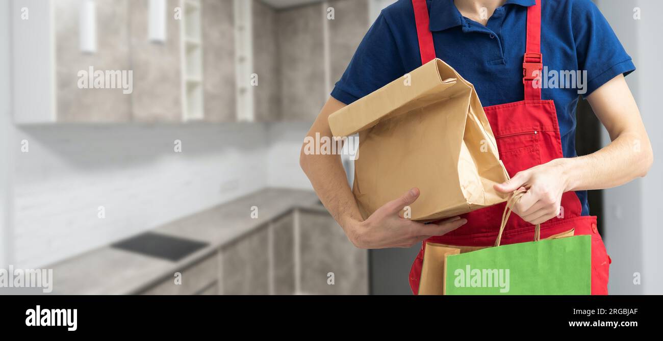 Courier holding paper bags with food, space for text. Delivery service ...