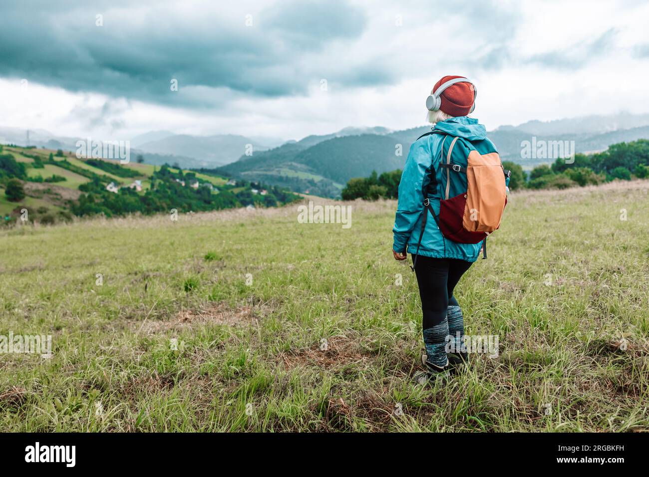 Happy active senior tourist woman listening to music in outdoor leisure ...