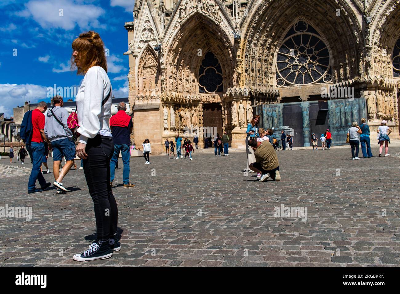 Reims, France - August 07, 2022 People wandering in the street of Reims ...