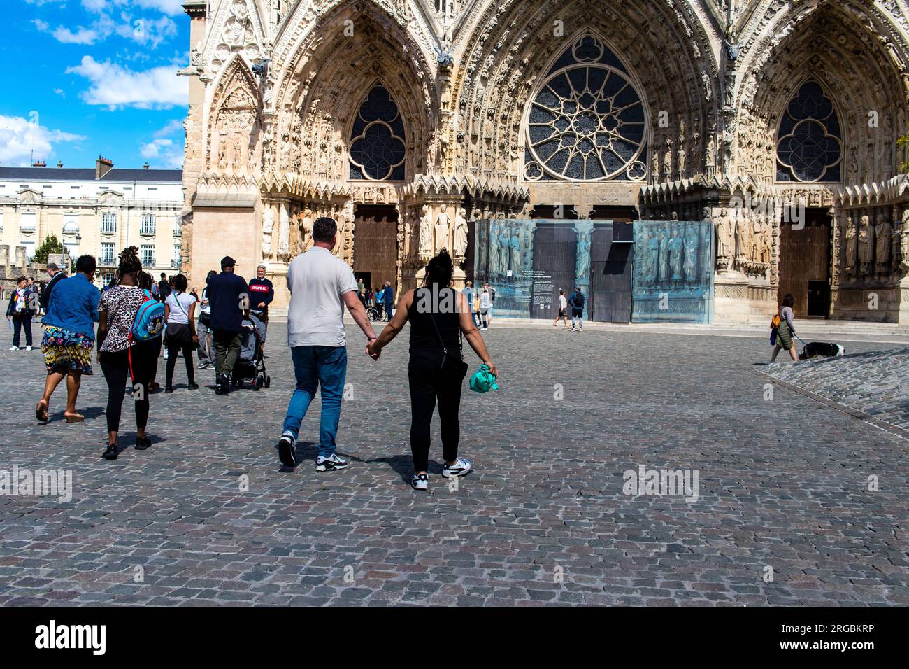 Reims, France - August 07, 2022 People wandering in the street of Reims ...