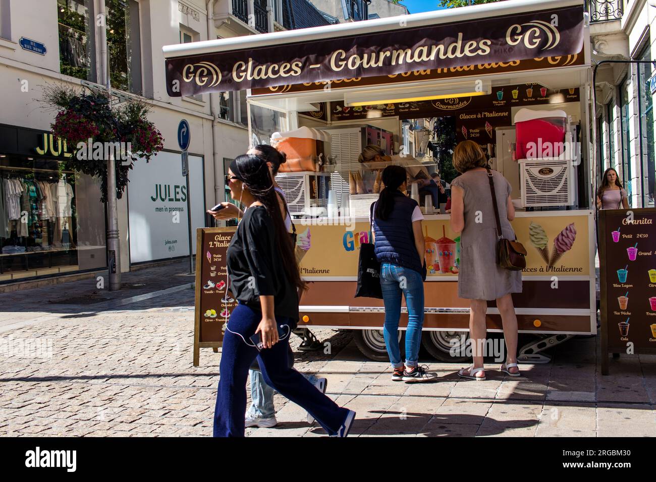 Reims, France - August 07, 2022 People wandering in the street of Reims ...