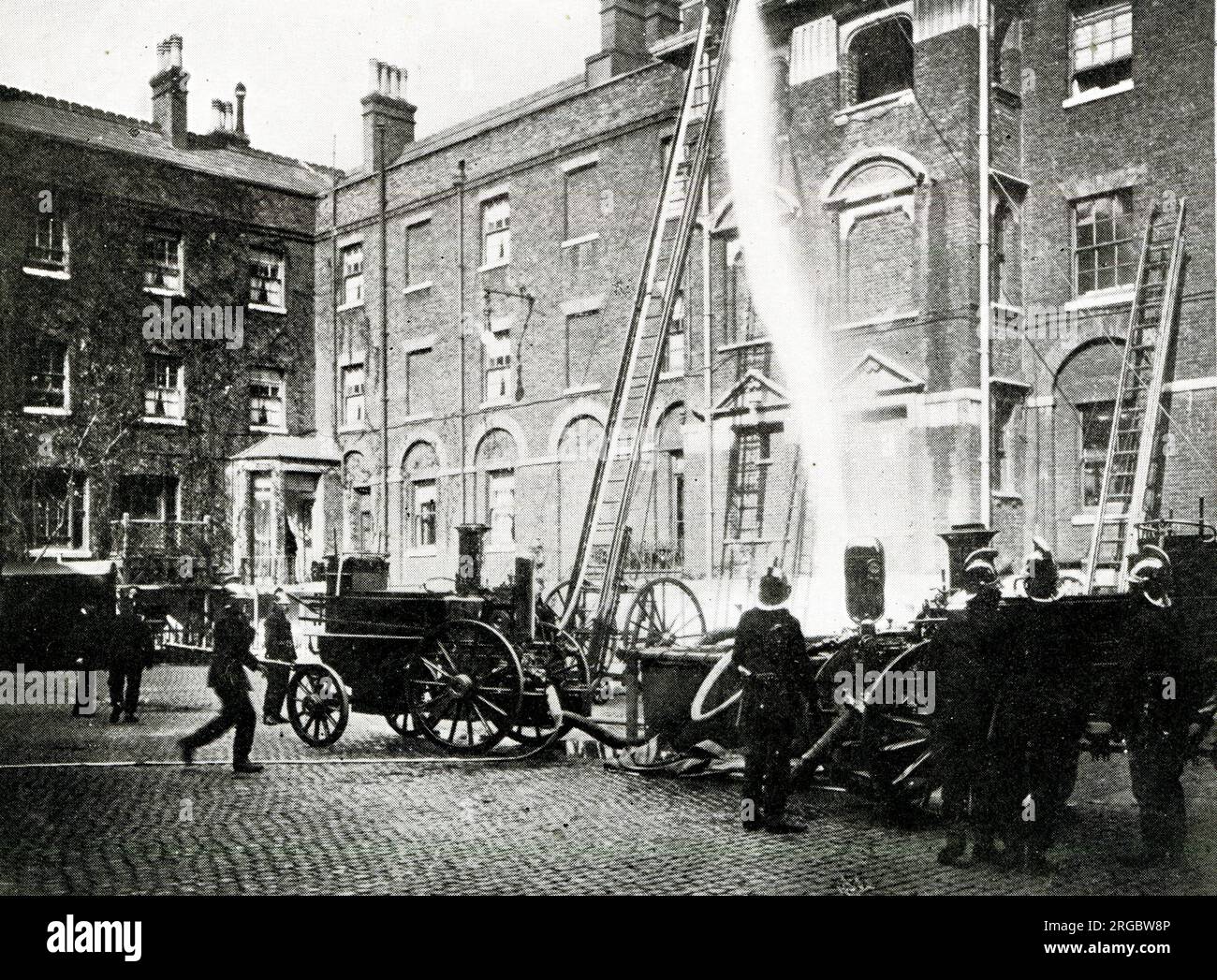 Firemen and fire engine at work in London Stock Photo - Alamy