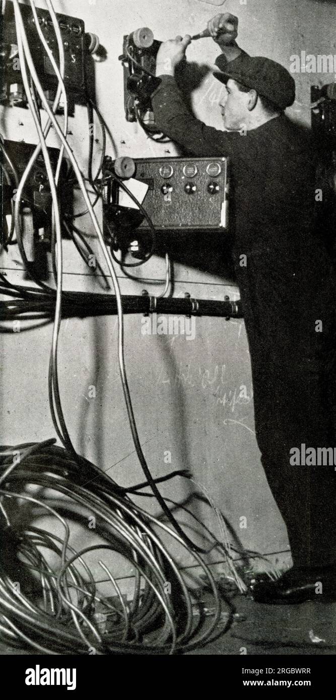 Telephone engineer working on RMS Queen Mary prior to launch Stock ...