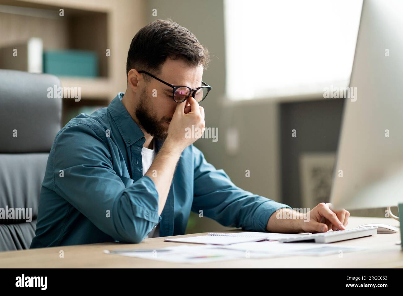Tired Millennial Businessman Suffering Eye Strain While Using Computer ...
