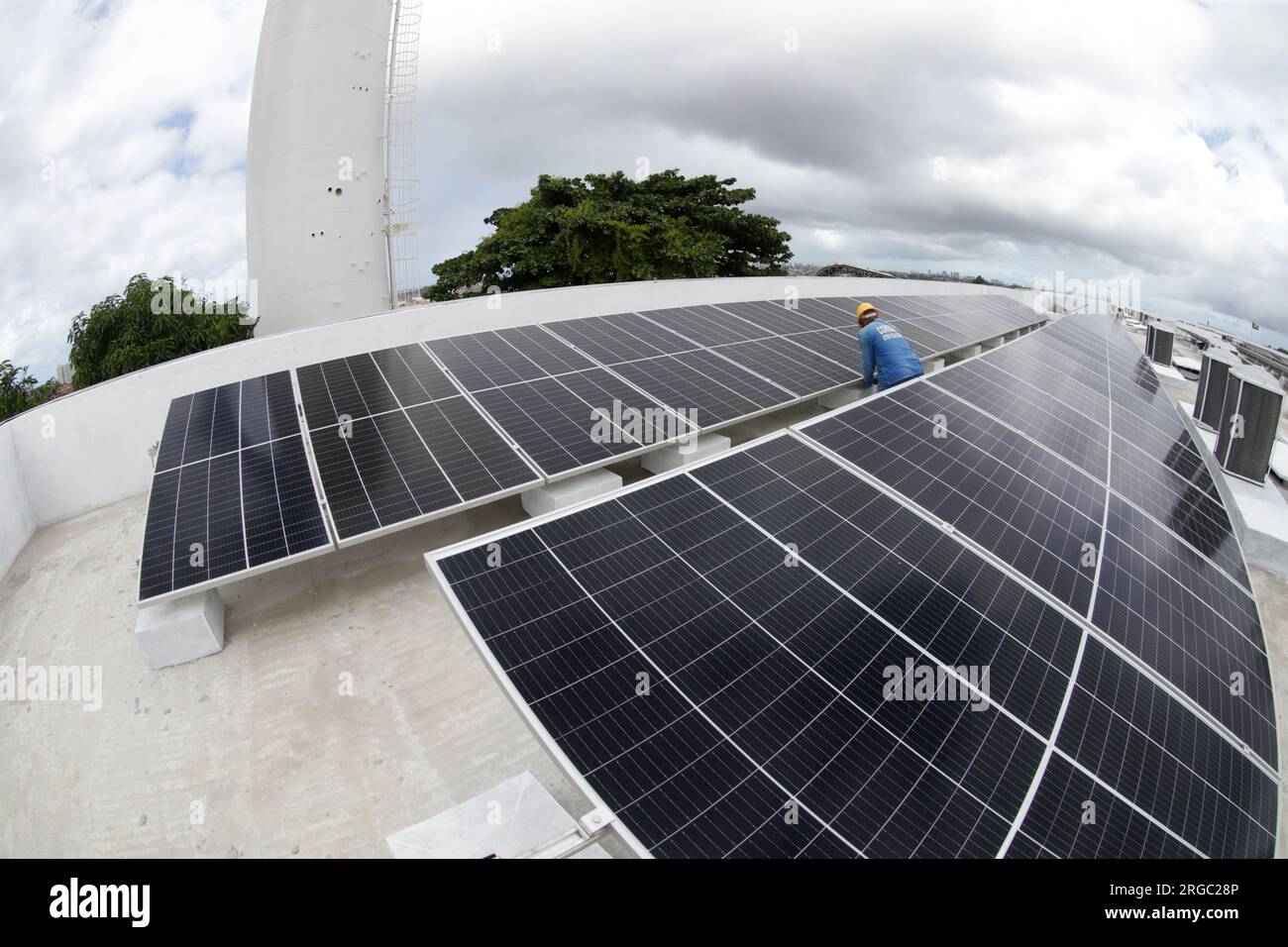 salvador, bahia, brazil - july 17, 2023: worker installs solar energy ...