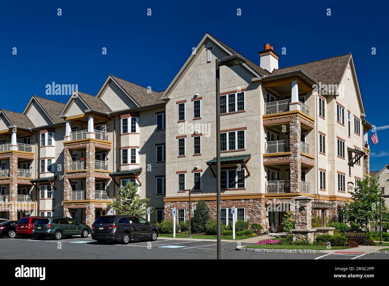 modern apartment building, 4 story, stone, stucco, balconies, cars ...
