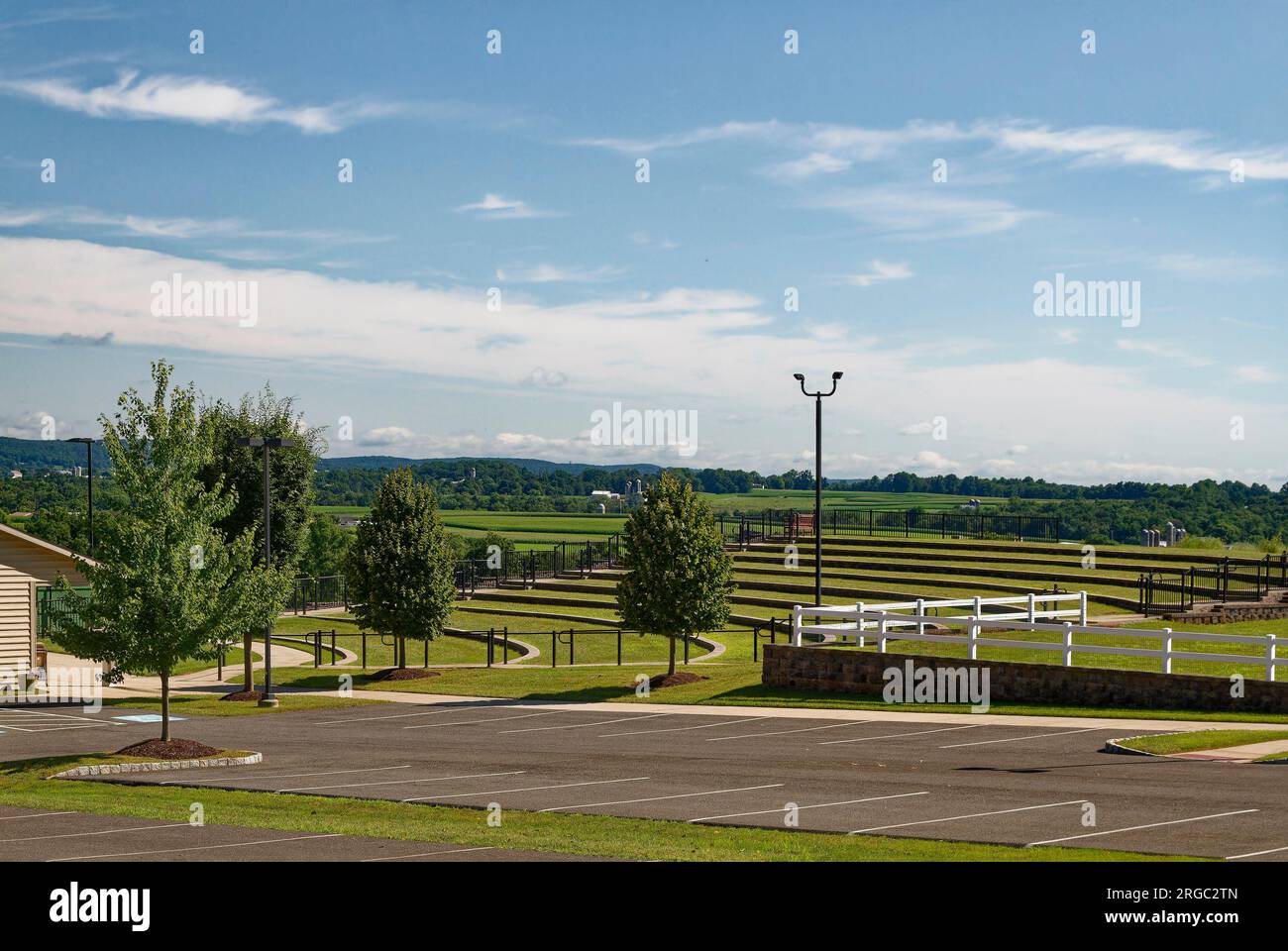 outdoor amphitheater, concert venue, grassy, trees, farms beyond, big ...