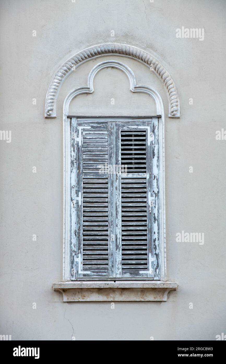 distressed shabby chic style wooden shutters with arched window in ...