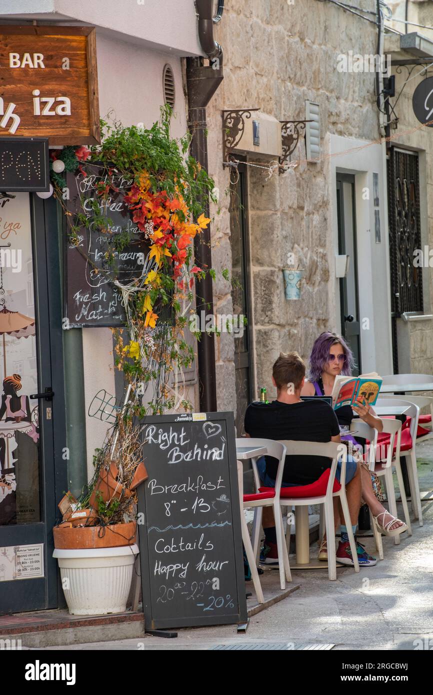 young couple enjoying a coffee at a small local cafe in grad split ...