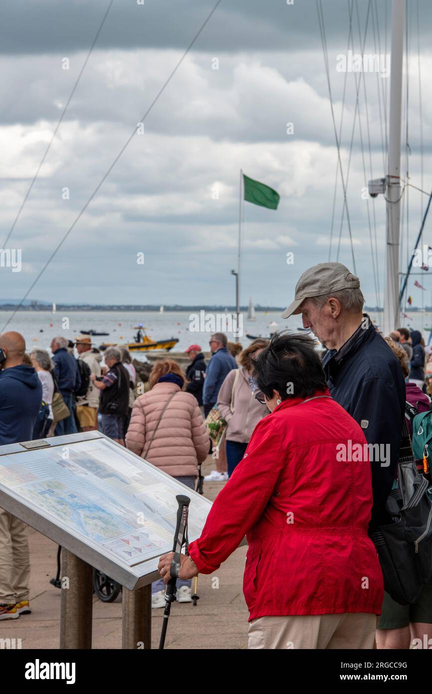 older couple looking at town map during cowes week regatta on the isle ...