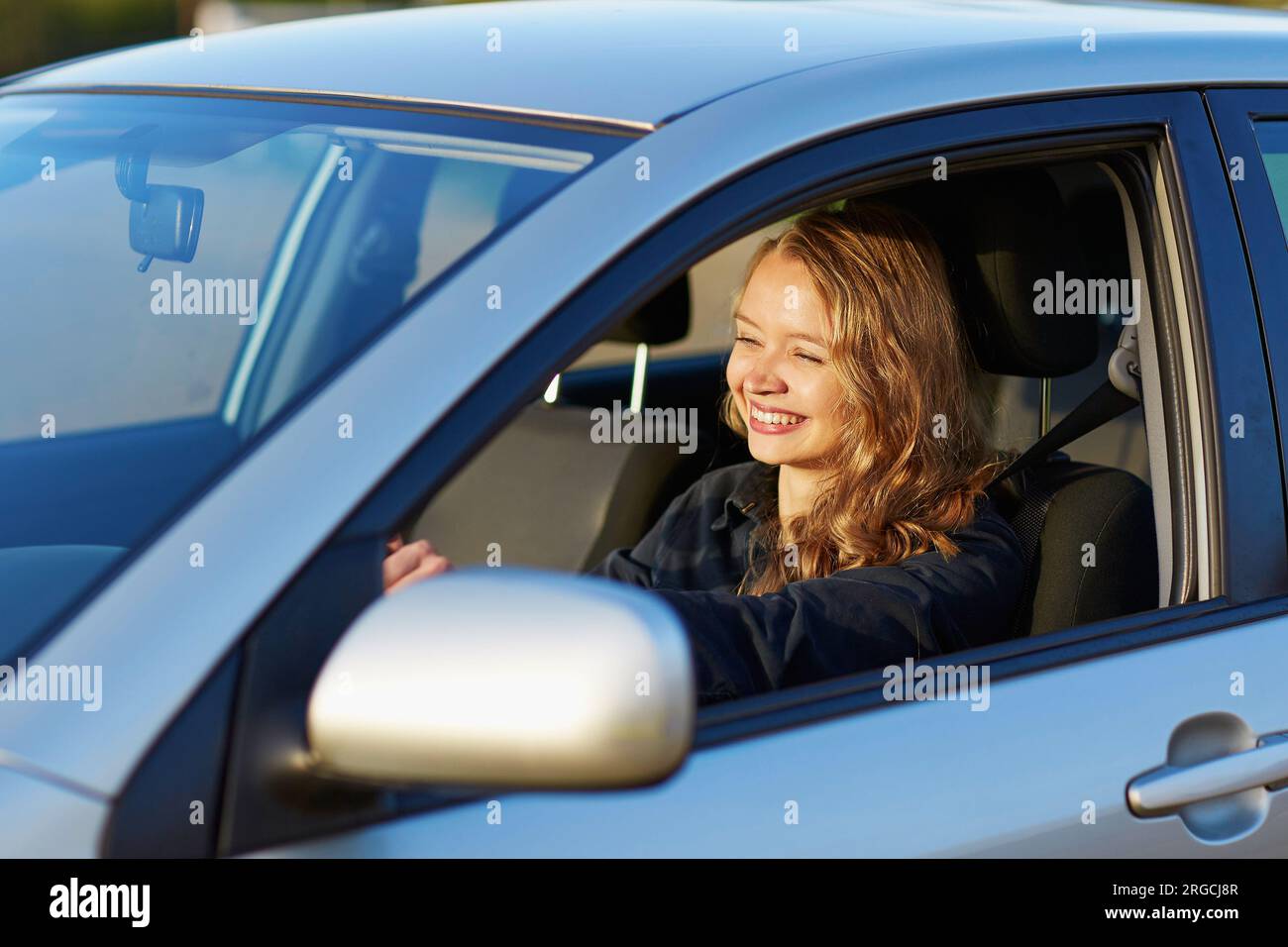 Beautiful and confident young woman driving a car Stock Photo - Alamy