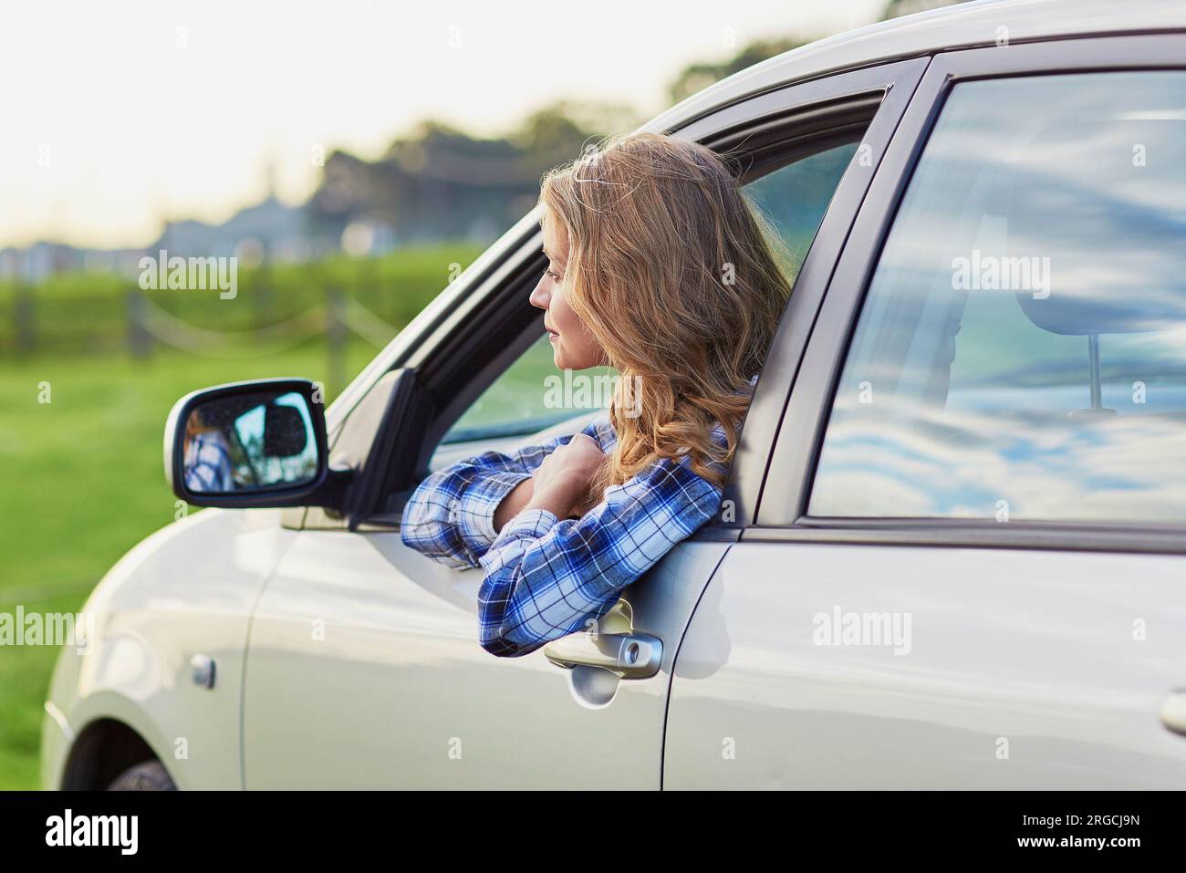 Beautiful young confident woman driving a car Stock Photo - Alamy
