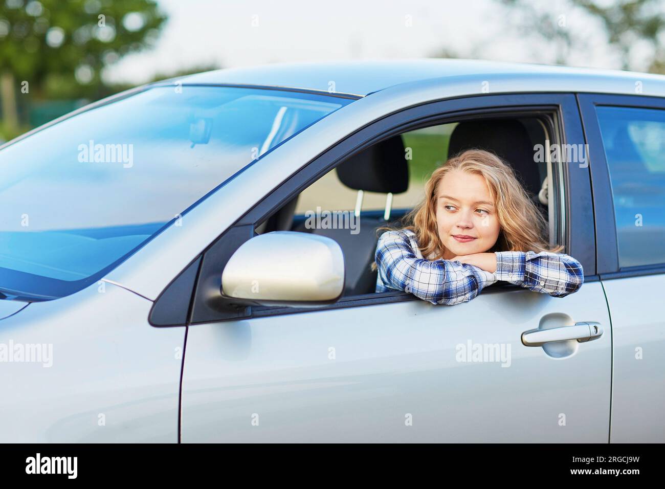 Beautiful young confident woman driving a car Stock Photo - Alamy