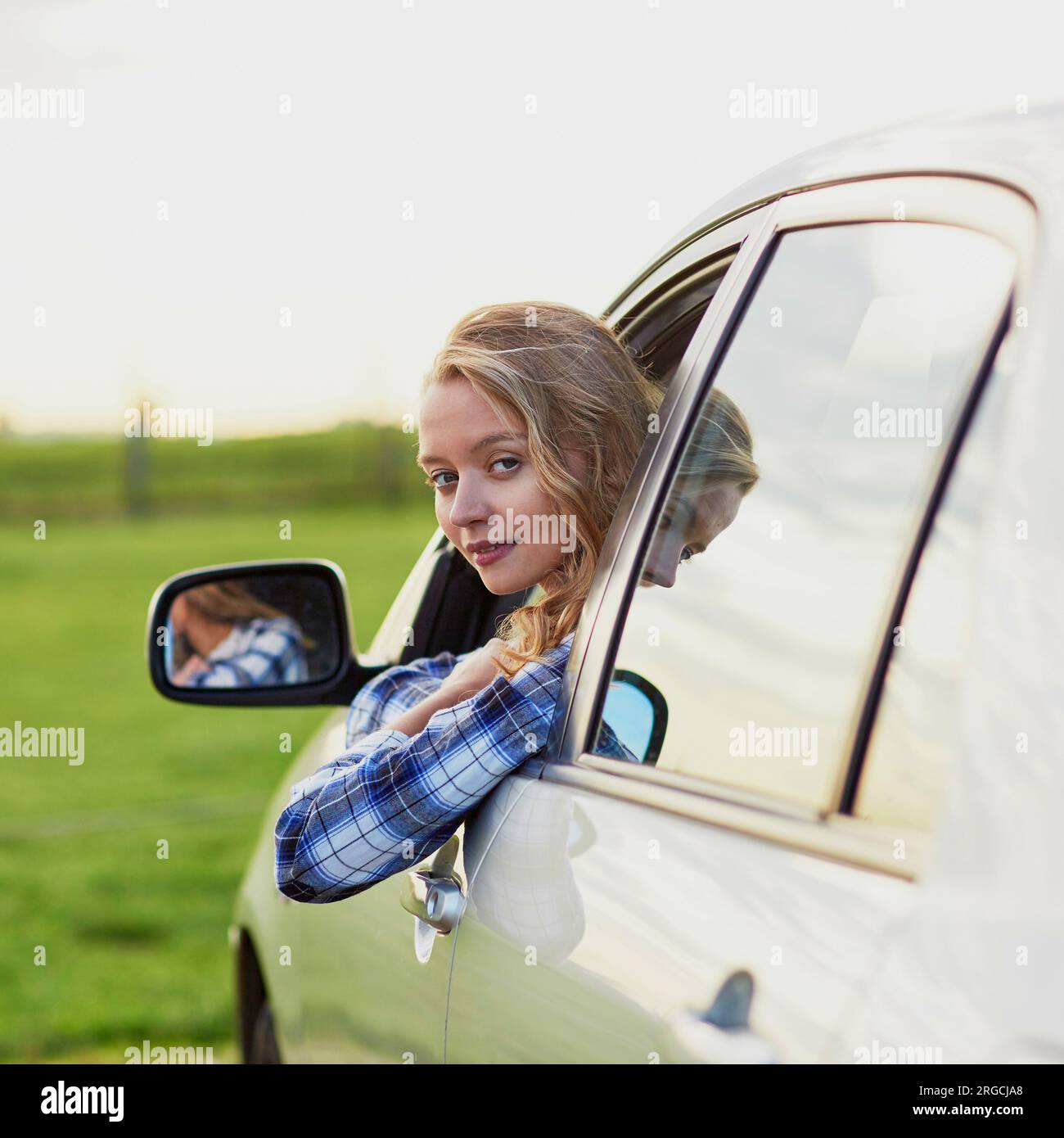 Beautiful young confident woman driving a car Stock Photo - Alamy