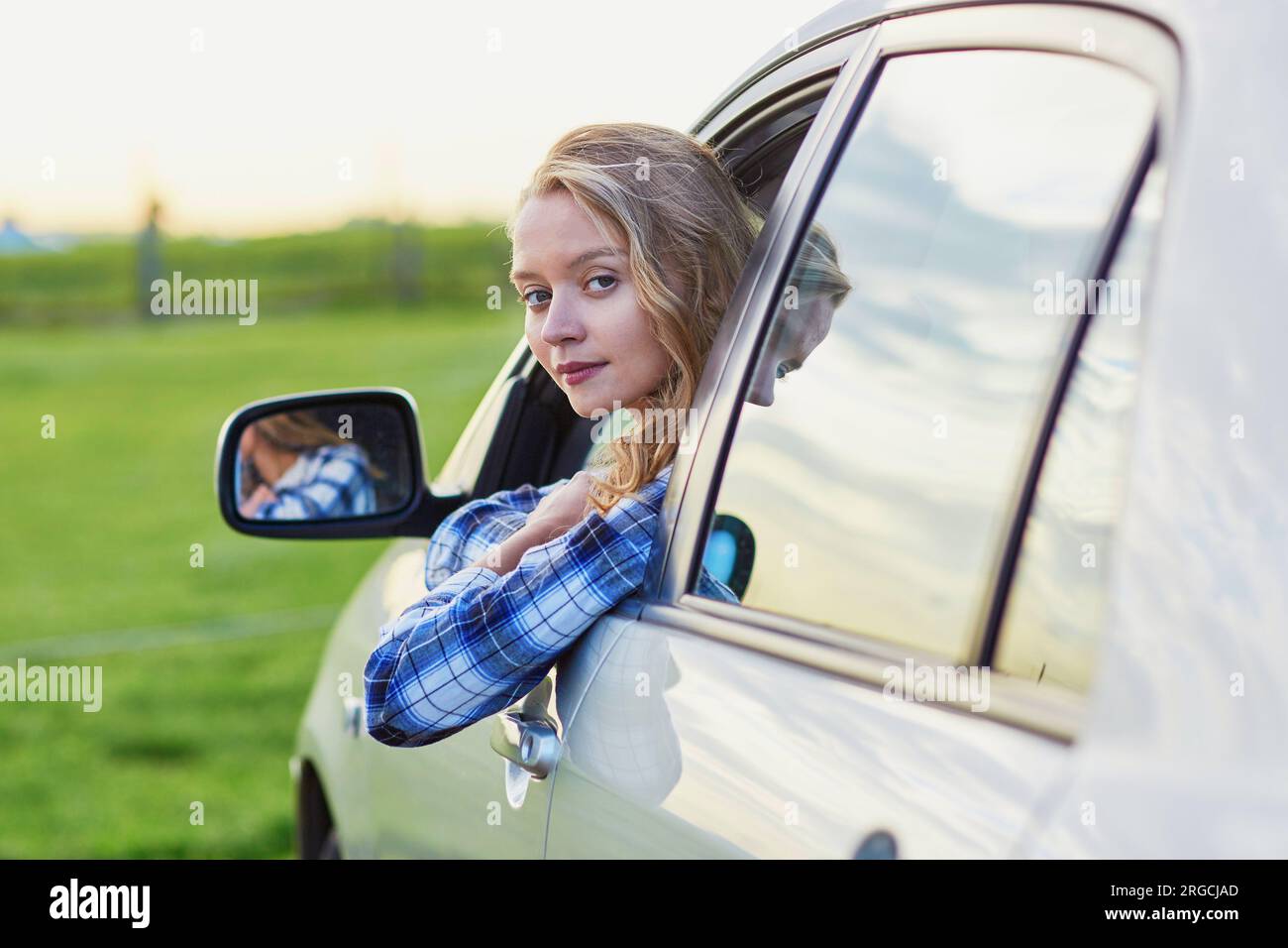 Beautiful young confident woman driving a car Stock Photo - Alamy