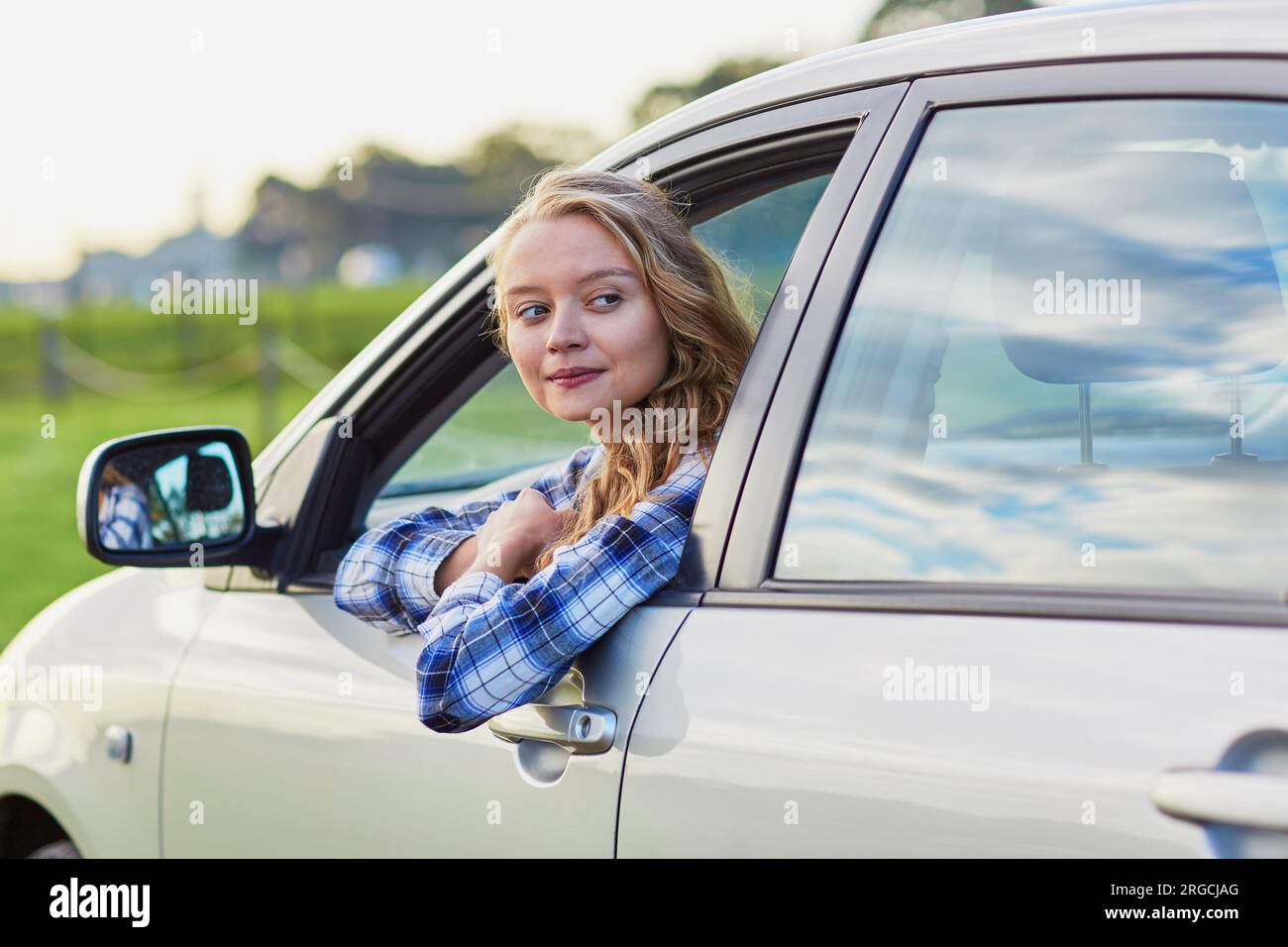 Beautiful young confident woman driving a car Stock Photo - Alamy