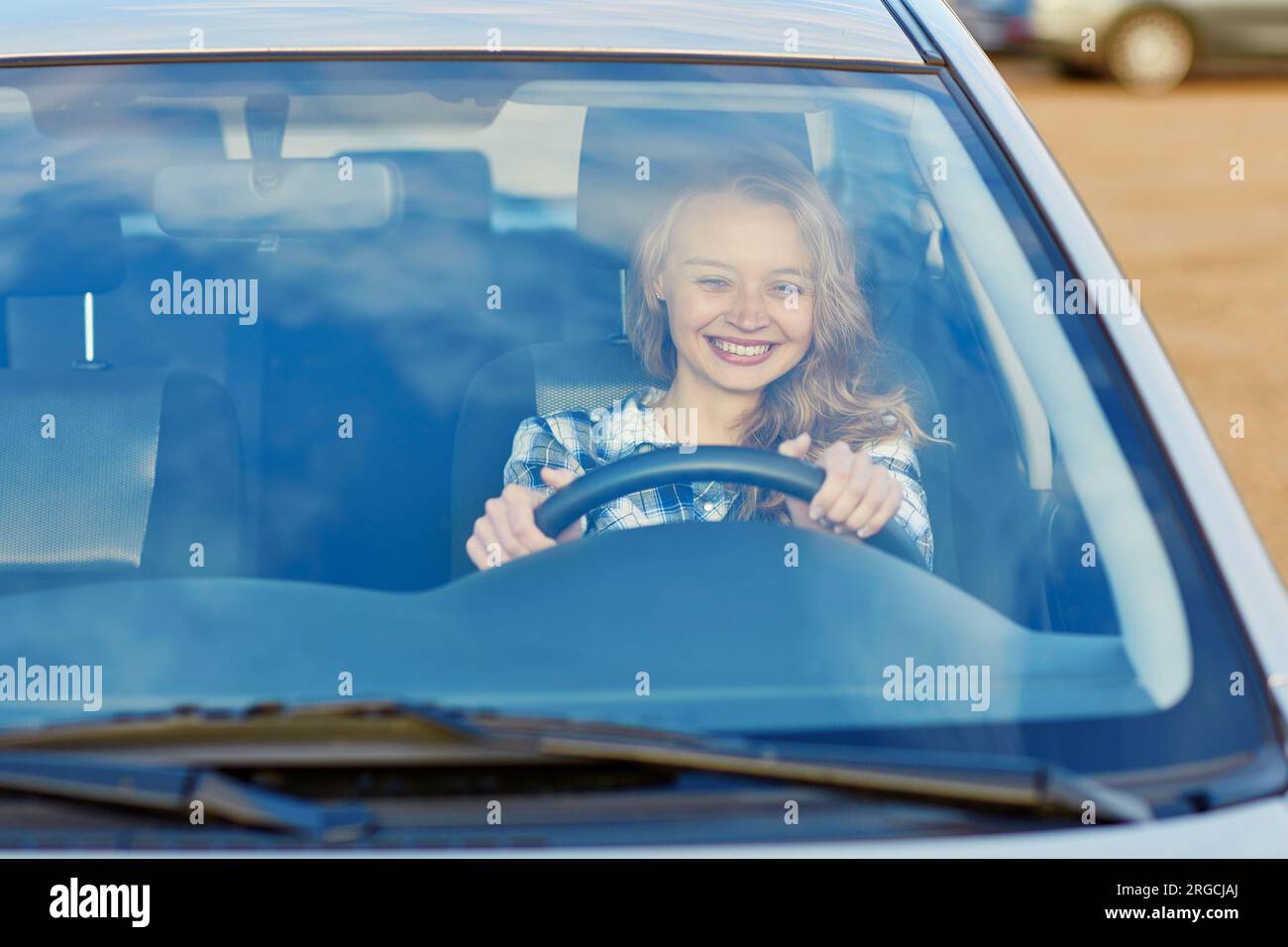 Beautiful and confident young woman driving a car Stock Photo - Alamy
