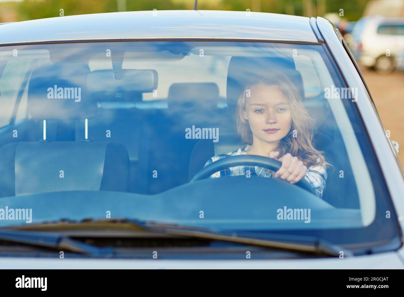 Beautiful young confident woman driving a car Stock Photo - Alamy