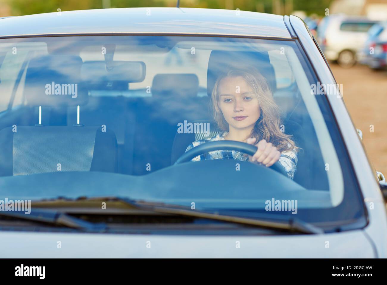 Beautiful young confident woman driving a car Stock Photo - Alamy