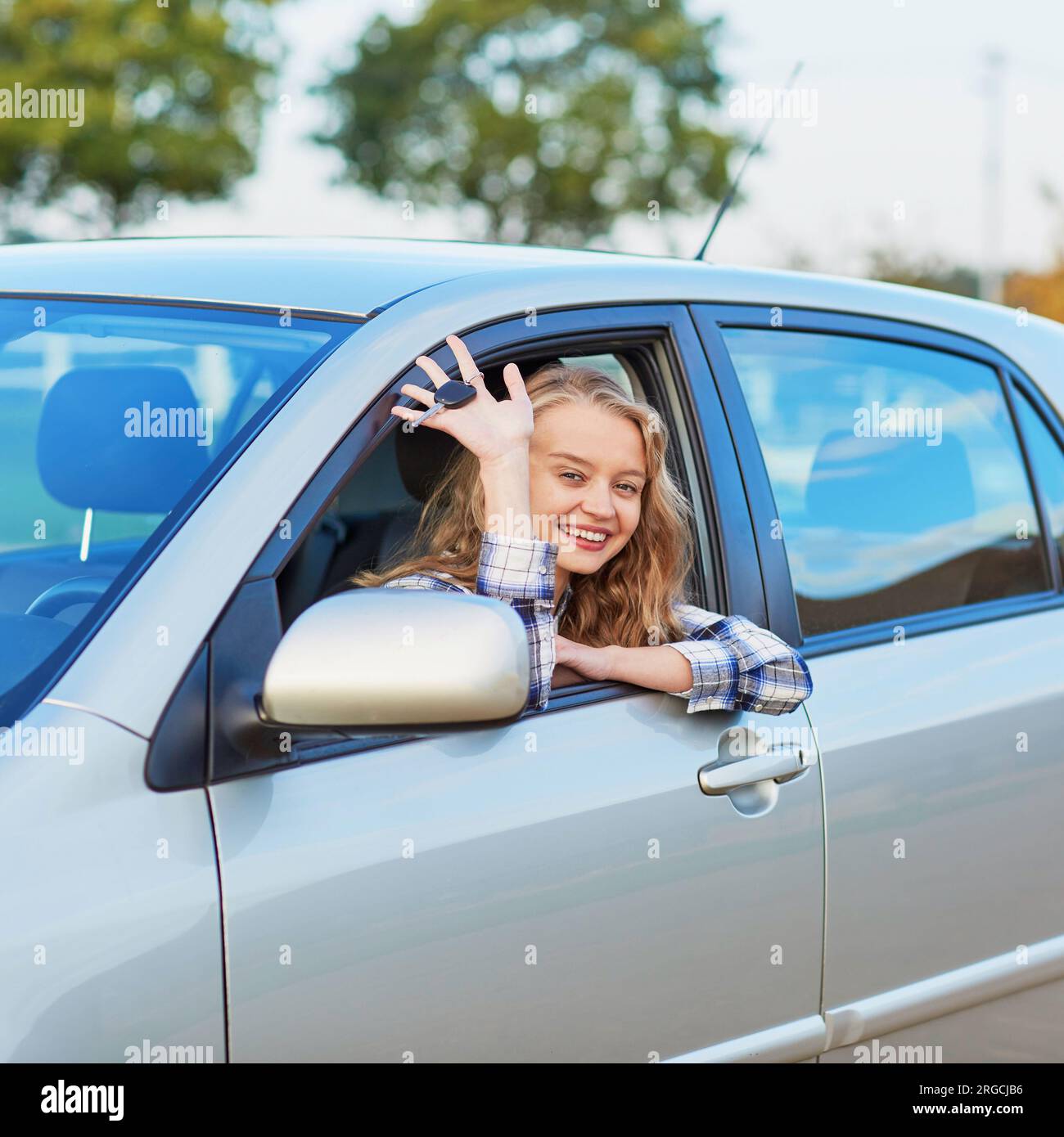 Beautiful young confident woman driving a car Stock Photo - Alamy