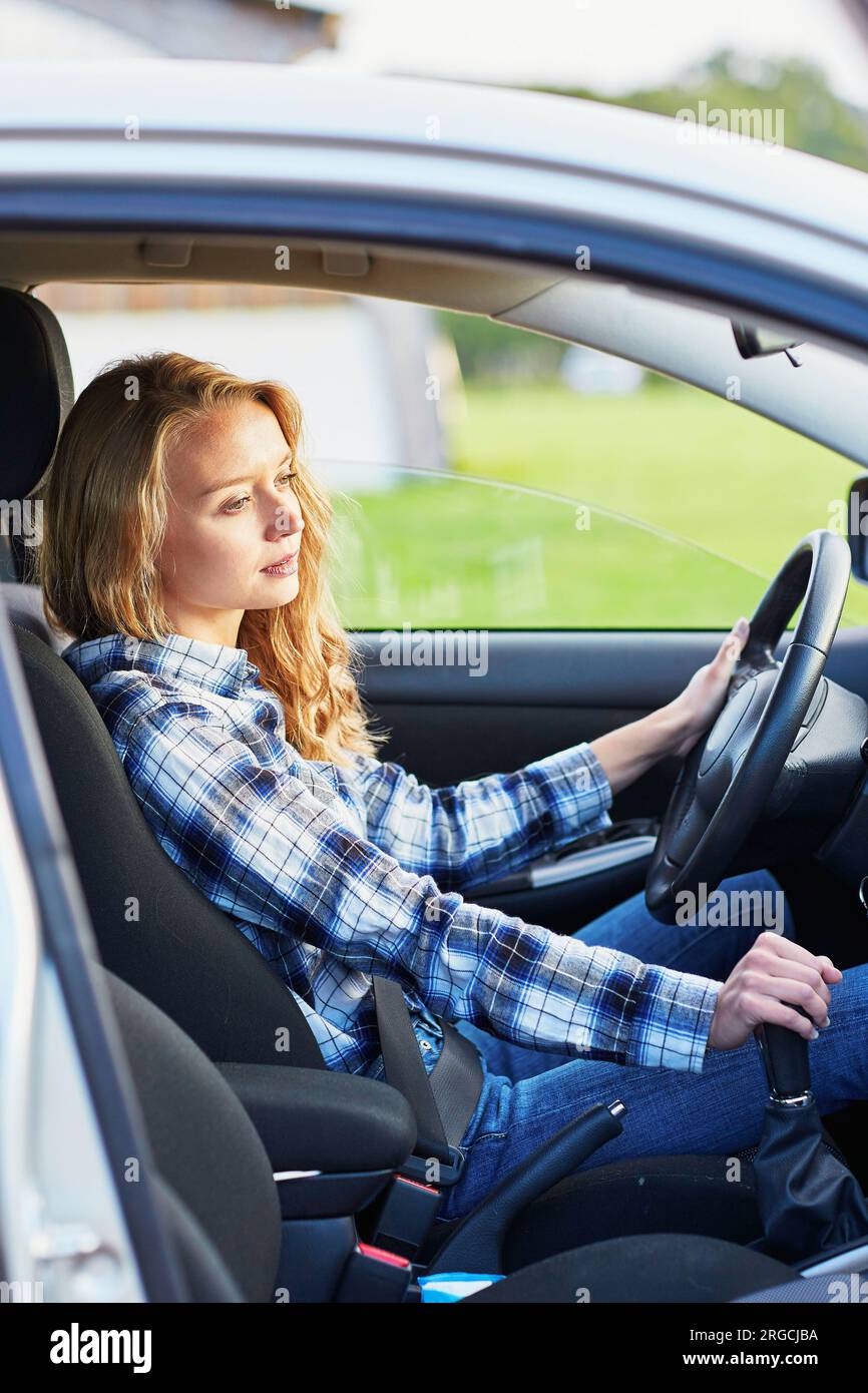 Beautiful and confident young woman driving a car Stock Photo - Alamy