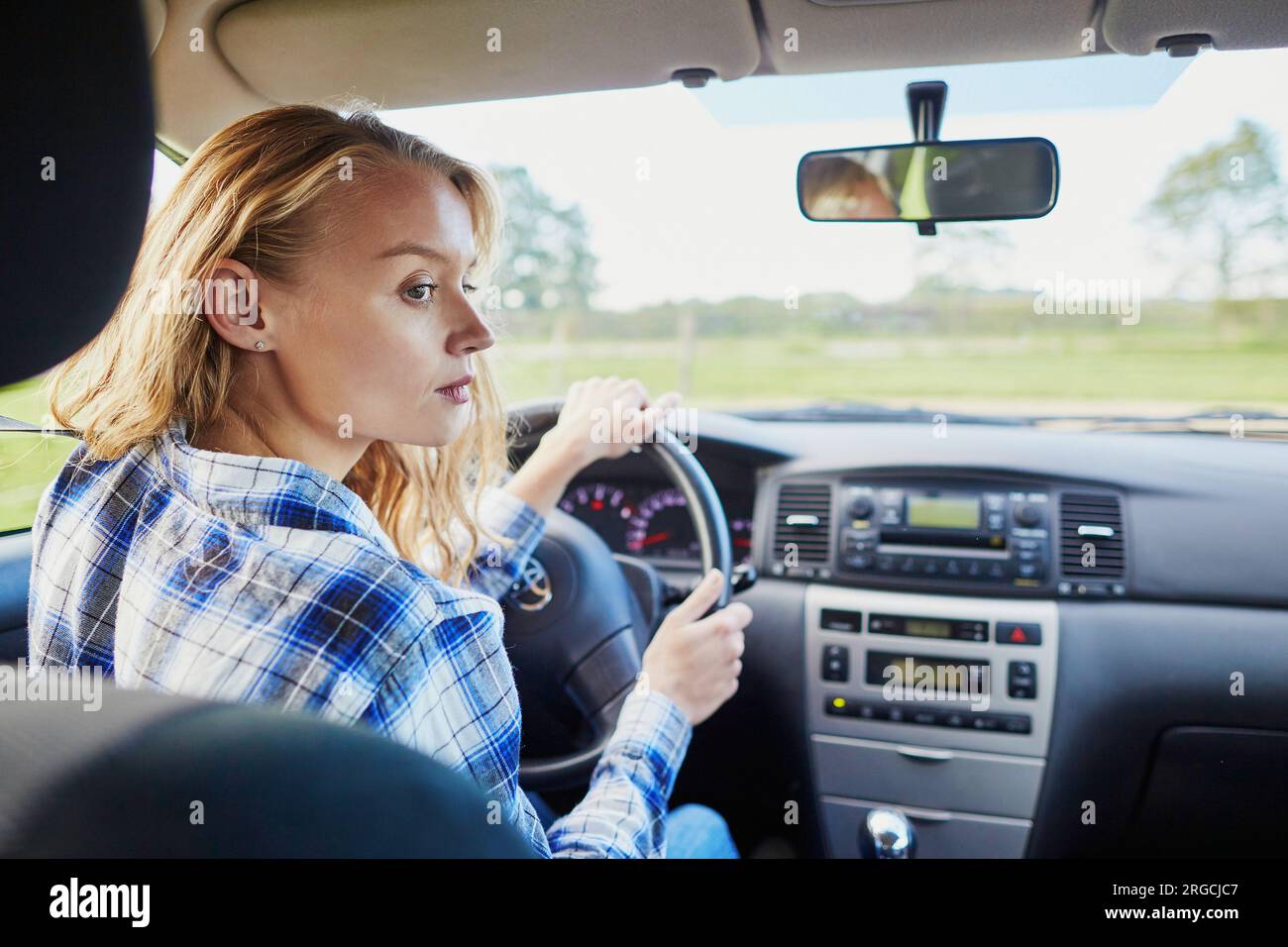 Beautiful and confident young woman driving a car Stock Photo - Alamy