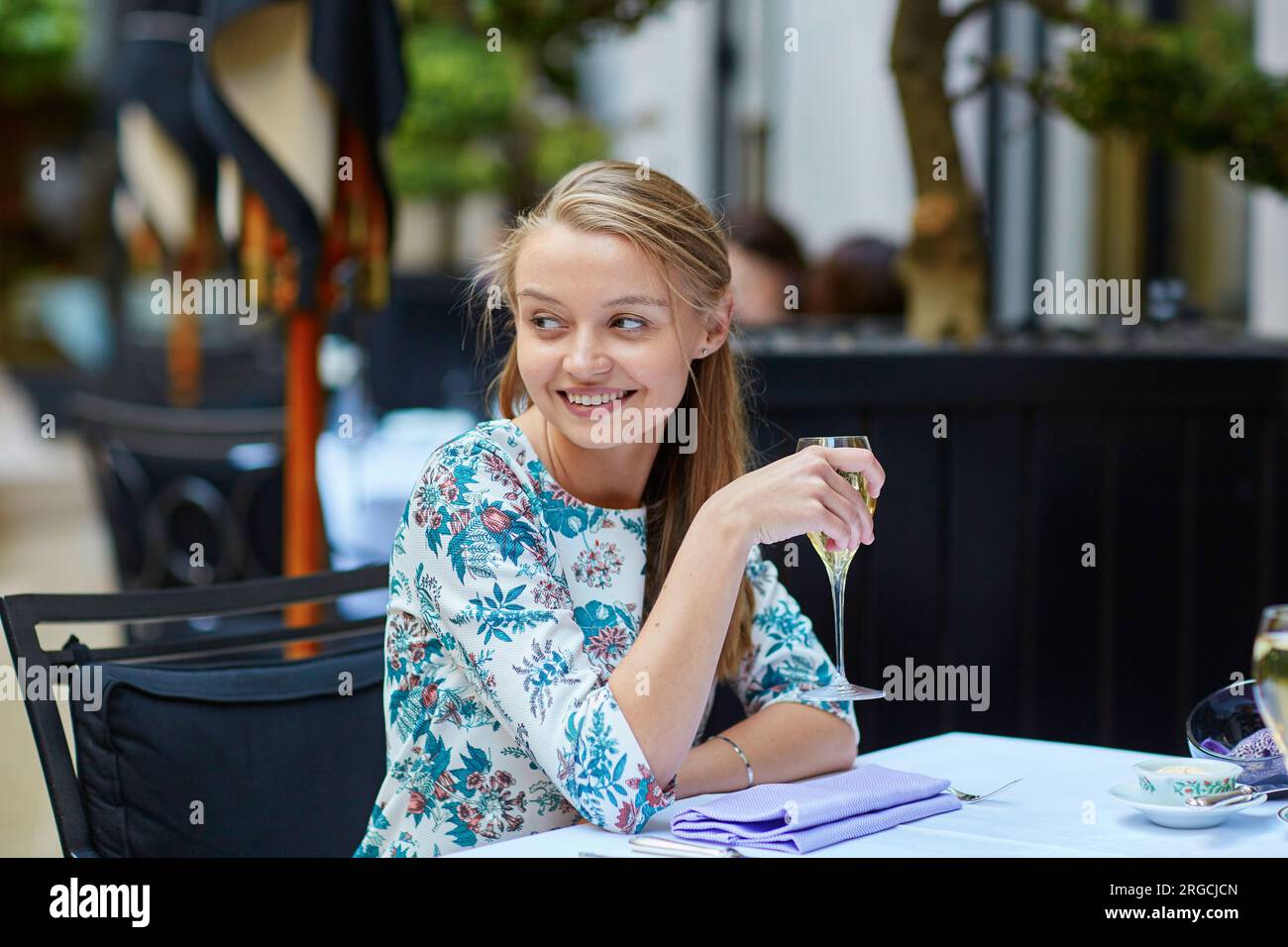 Beautiful young woman in a French restaurant drinking champagne Stock ...