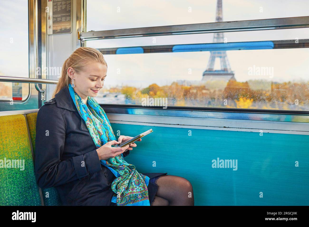 Beautiful young woman travelling in a train of Parisian underground and ...