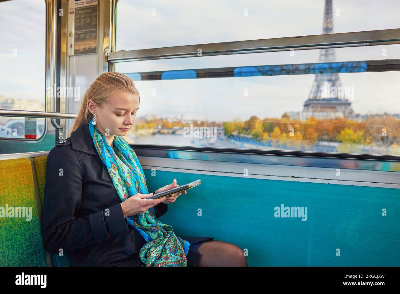 Beautiful young woman travelling in a train of Parisian underground and ...