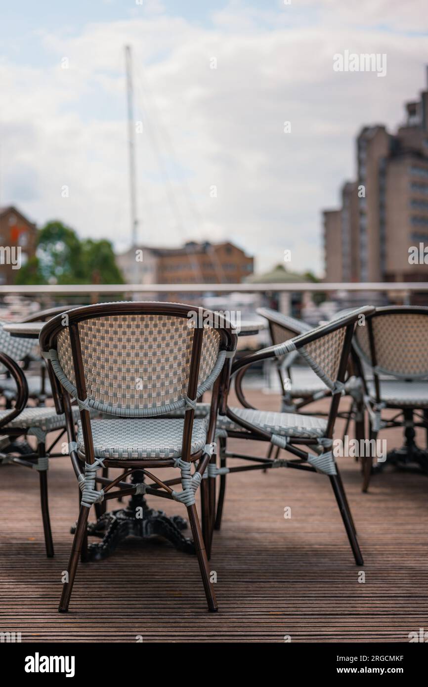 Empty outdoor restaurant tables and chairs in St Katherine's Dock in ...