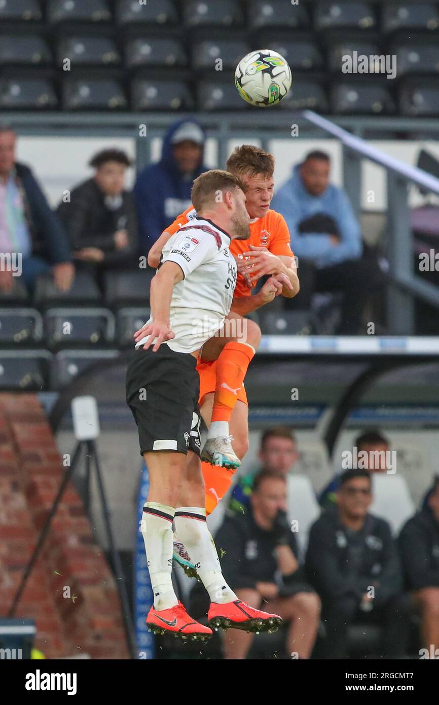 Callum Elder #20 of Derby County and Andy Lyons #24 of Blackpool battle ...